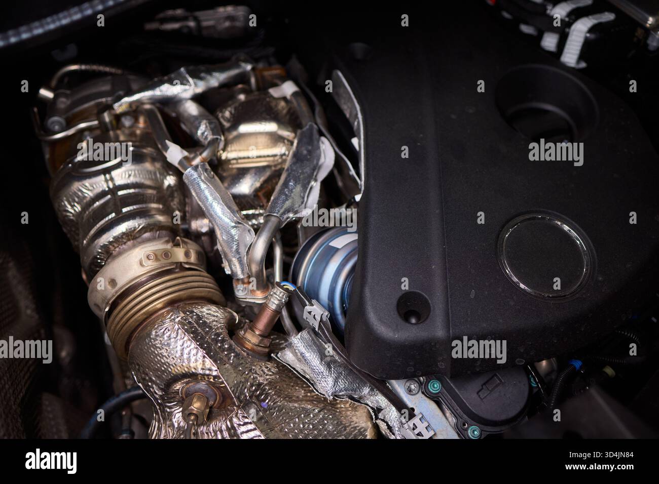 High-performance car engine bay showing polished intake runners ...