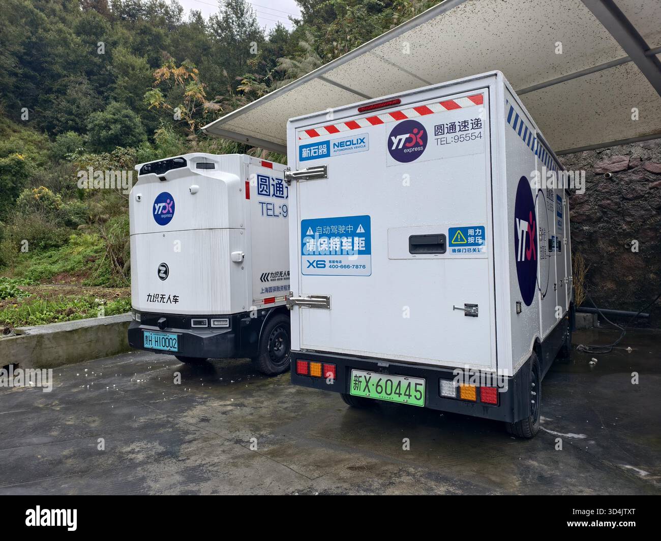 Workers sort parcels at a logistics park in Rongjiang County ...