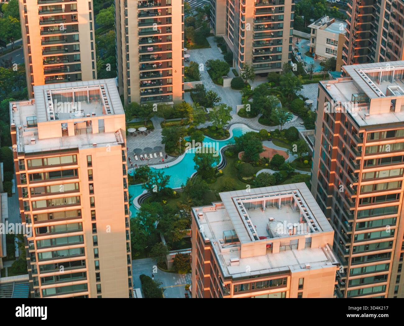 Aerial view of modern residential area featuring greenery, water ...