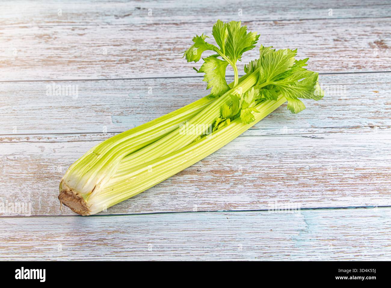 Raw green selery stem with leaves for cooking Stock Photo - Alamy