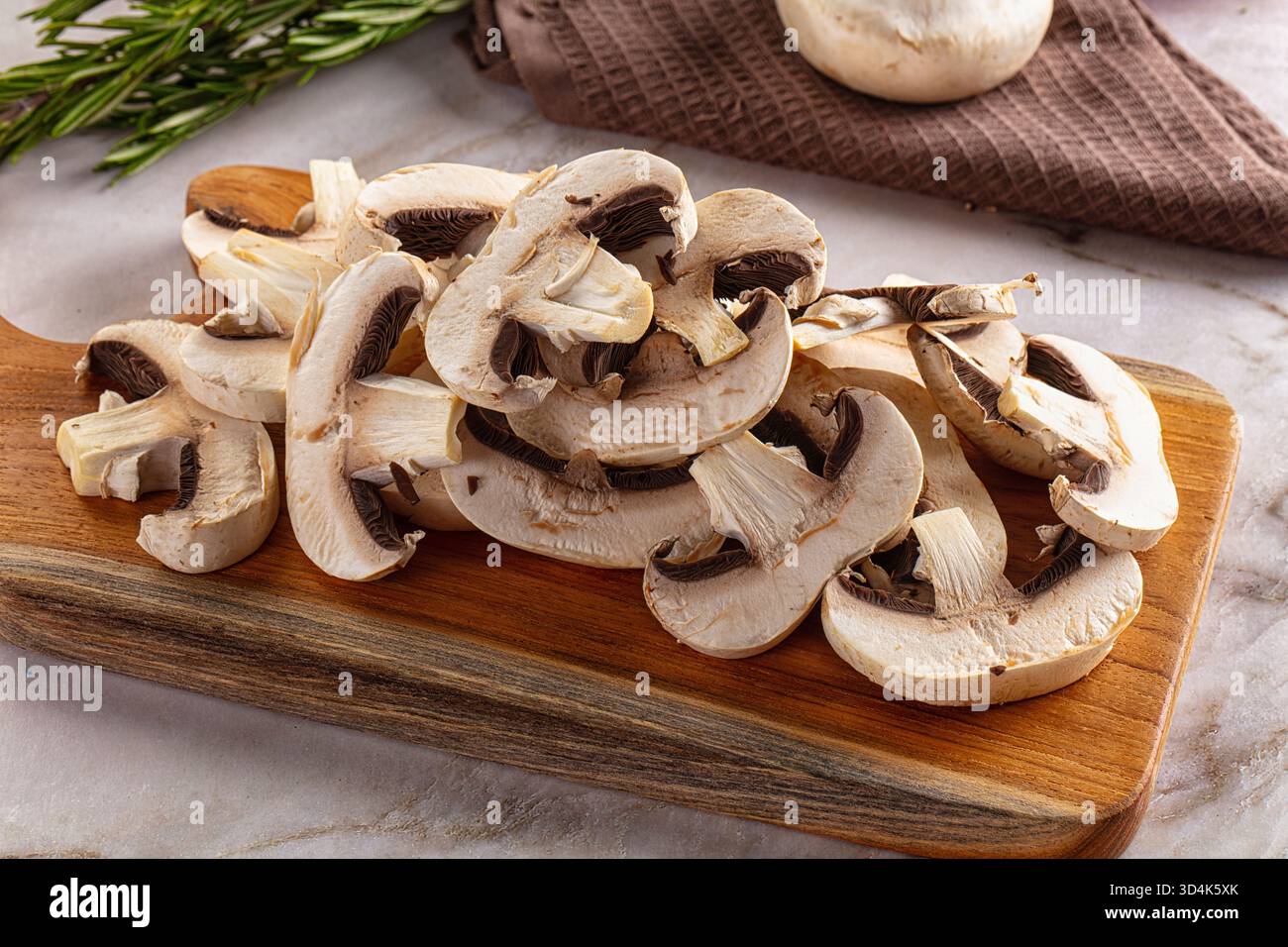 Raw champignon slices heap on the board Stock Photo - Alamy