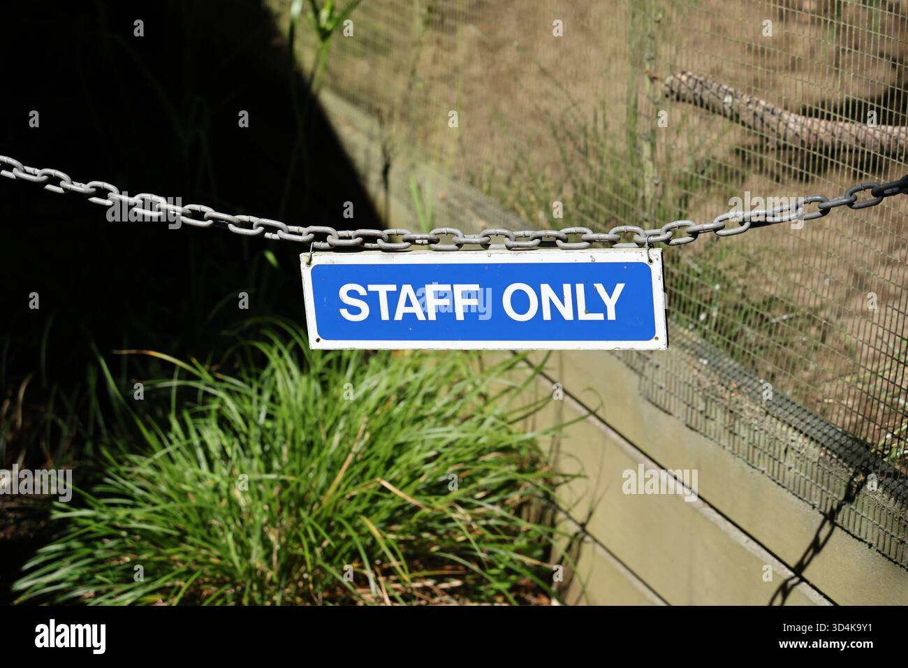 Blue staff only sign on chain Stock Photo - Alamy