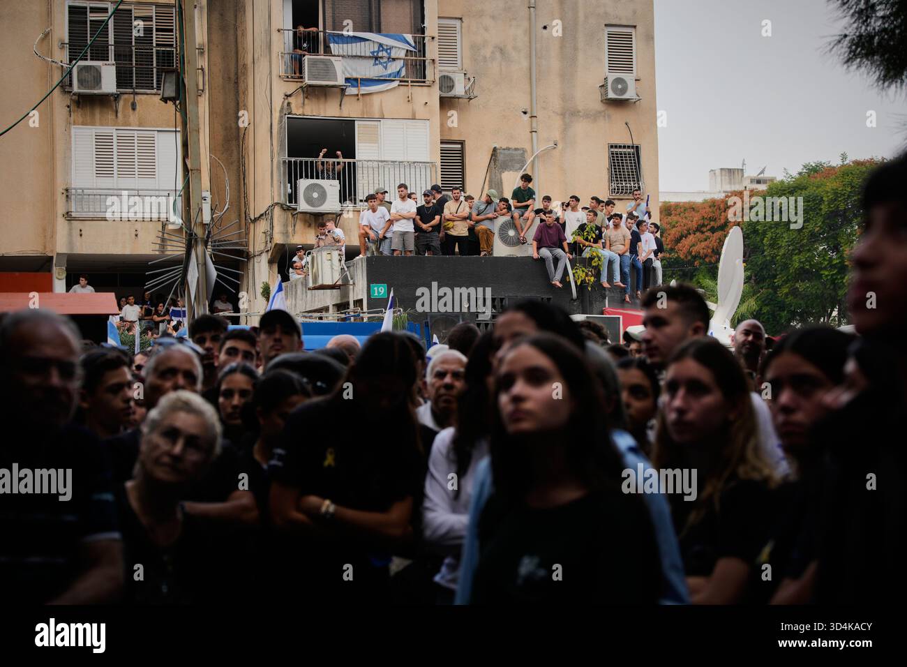 People attend the funeral of Hadar Goldin, an Israeli soldier killed in ...