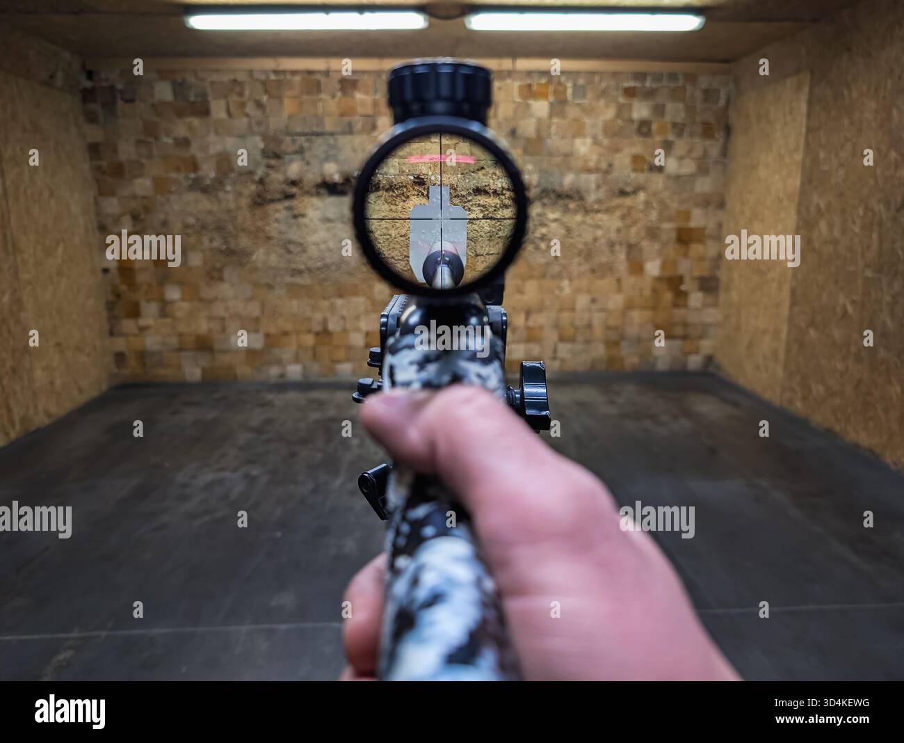 First-person view of aiming a rifle through an optical scope at a ...