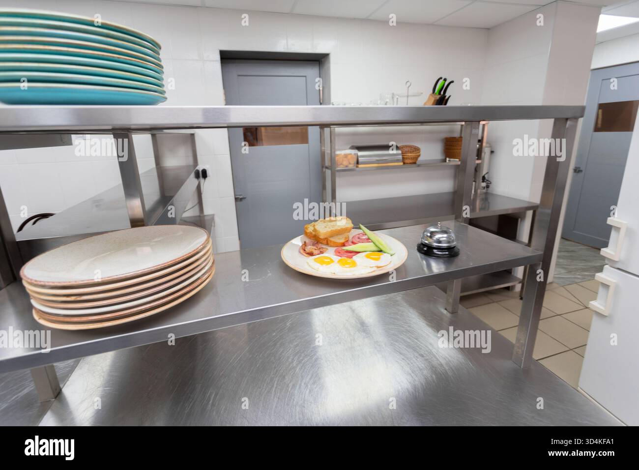 Clean kitchen space with prepared breakfast items and organized dishes ...