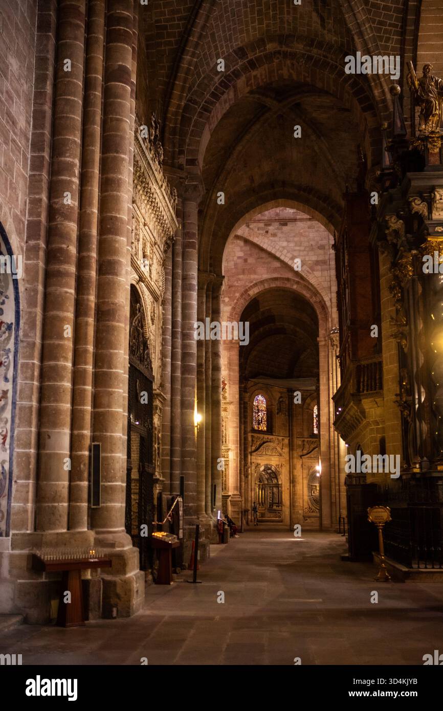 The interior of a grand cathedral features tall stone arches and ...