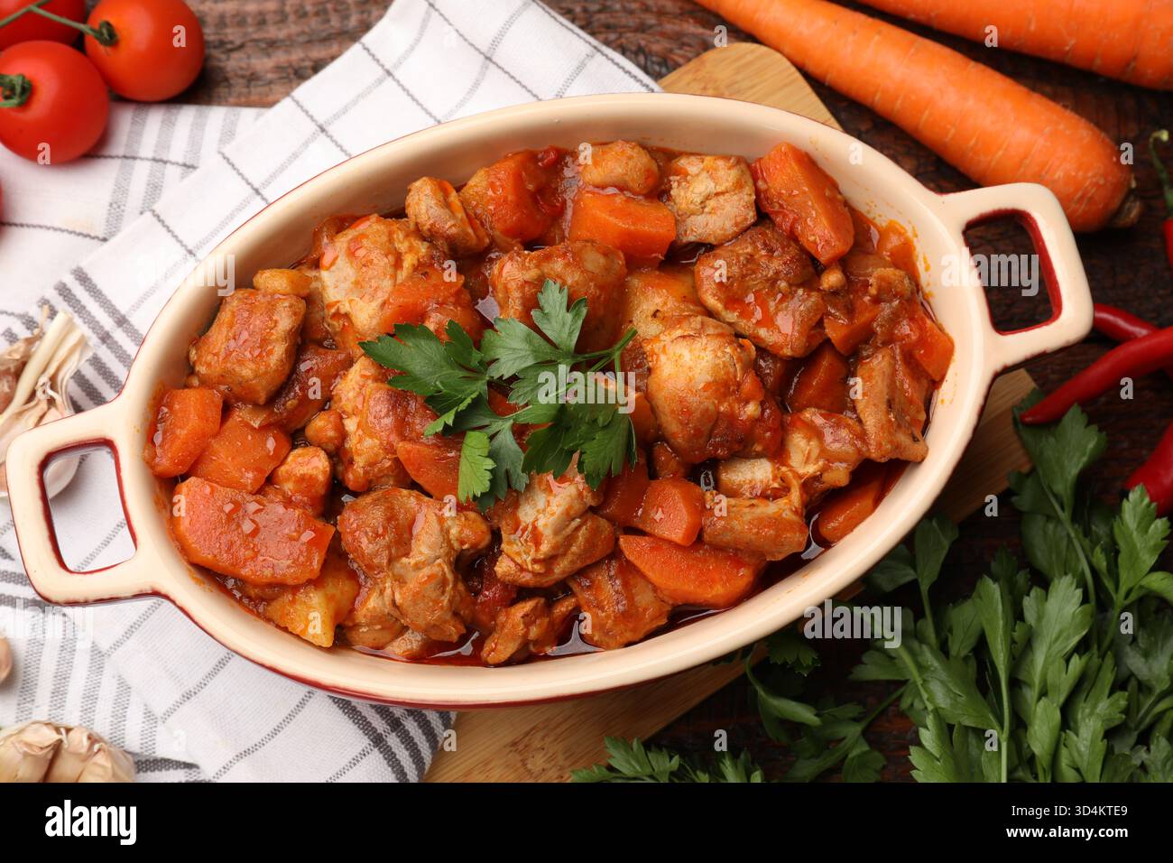 Delicious cooked stew in baking dish and ingredients on table, flat lay ...