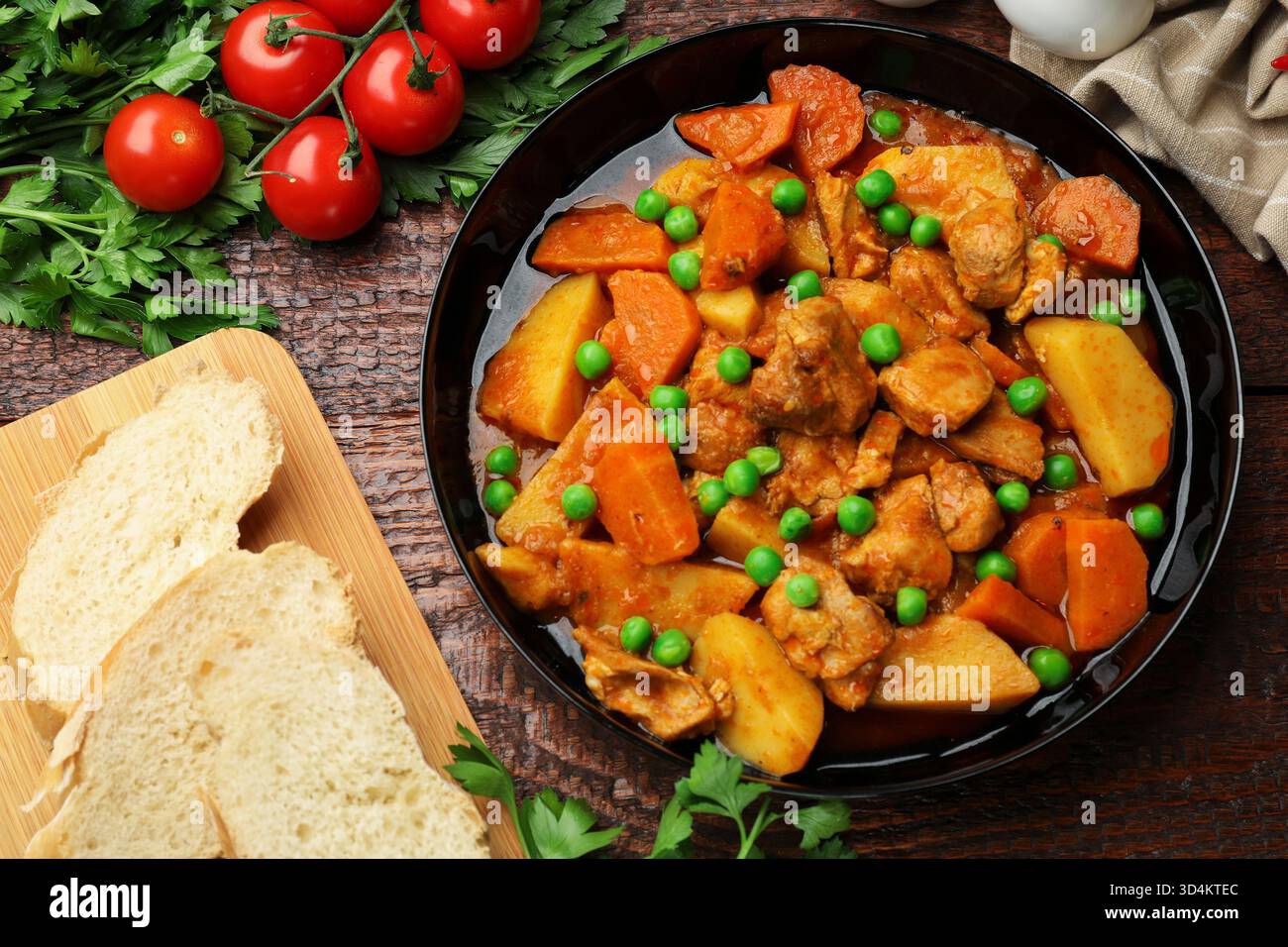 Delicious cooked stew served on wooden table, flat lay Stock Photo - Alamy
