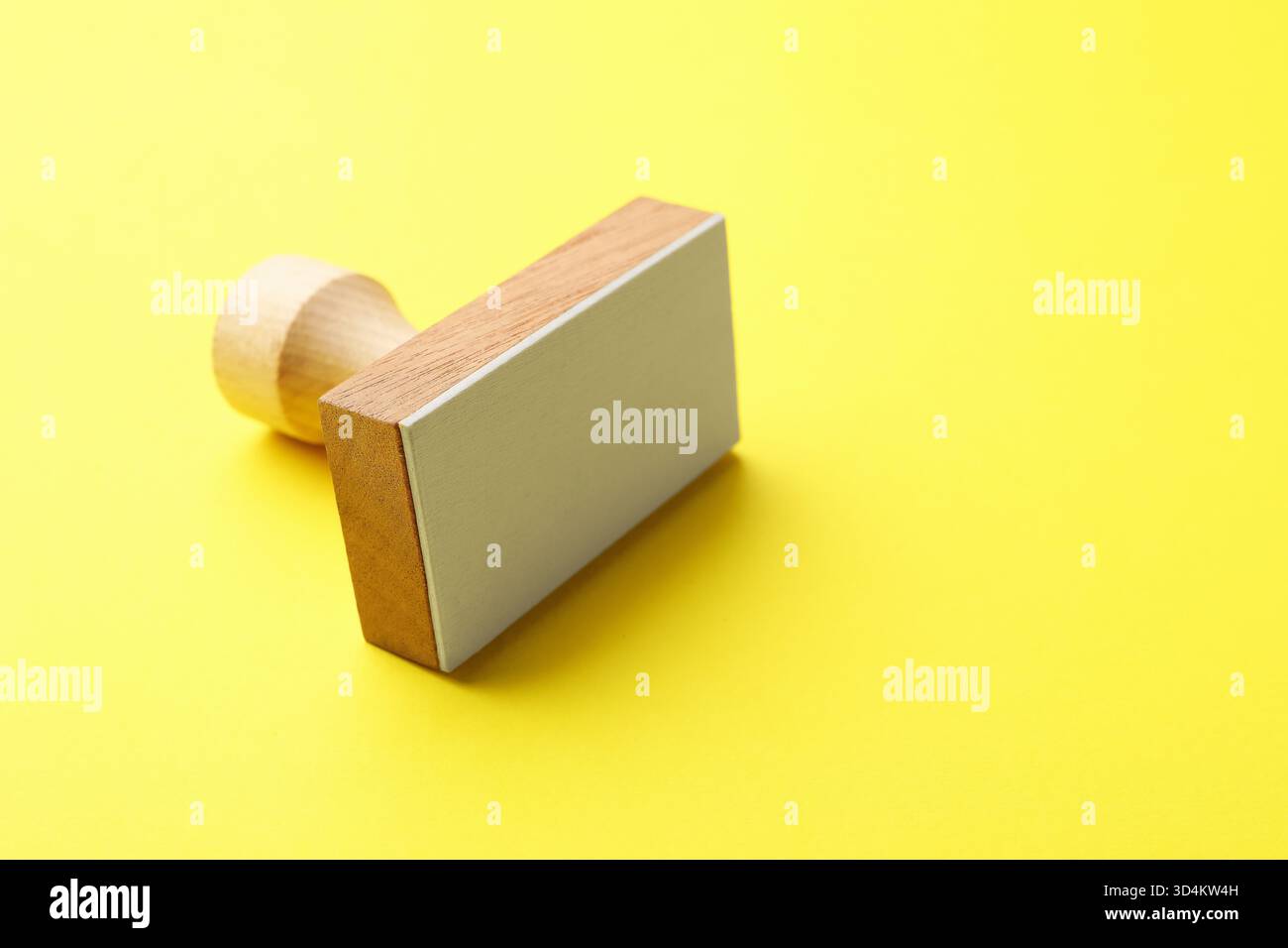 One wooden stamp on yellow background, closeup. Space for text Stock ...