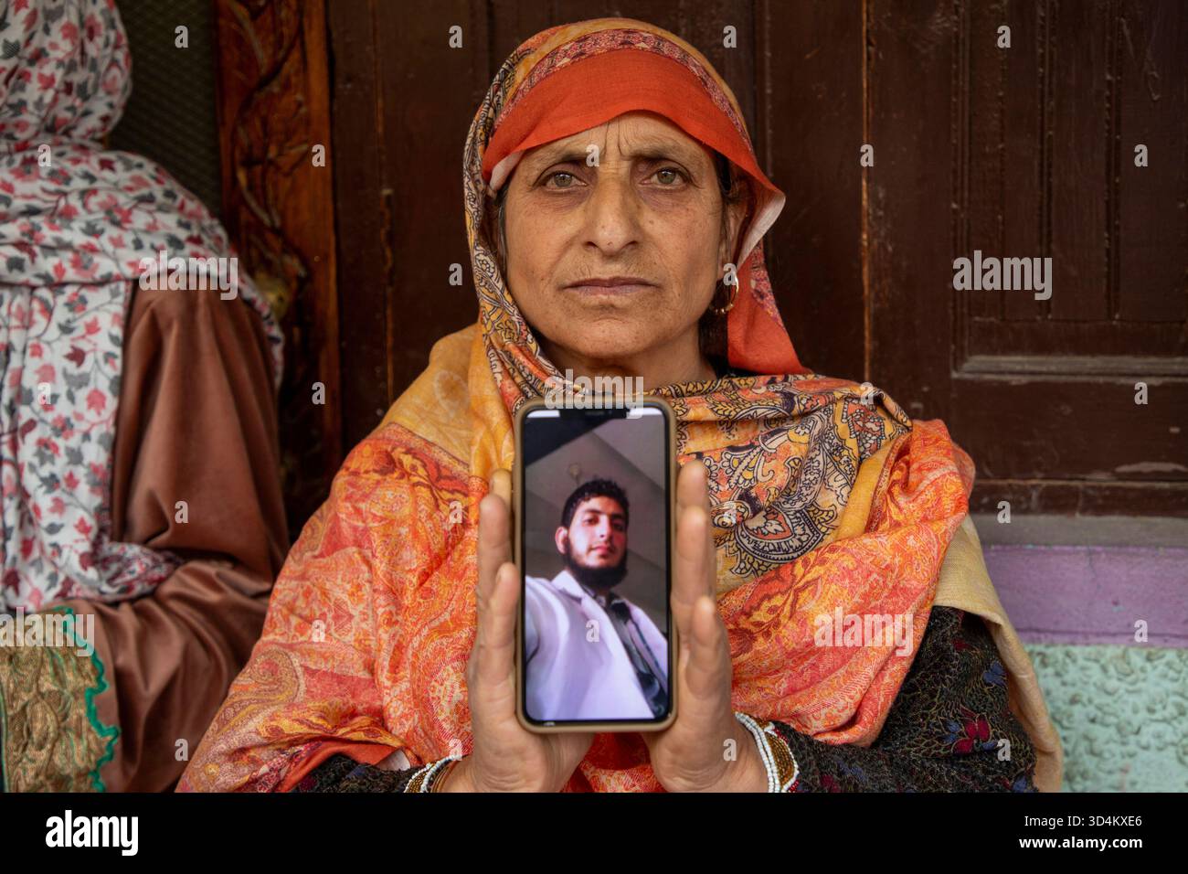 Mother of Kashmiri doctor Muzammil Shakeel shows his photograph at ...