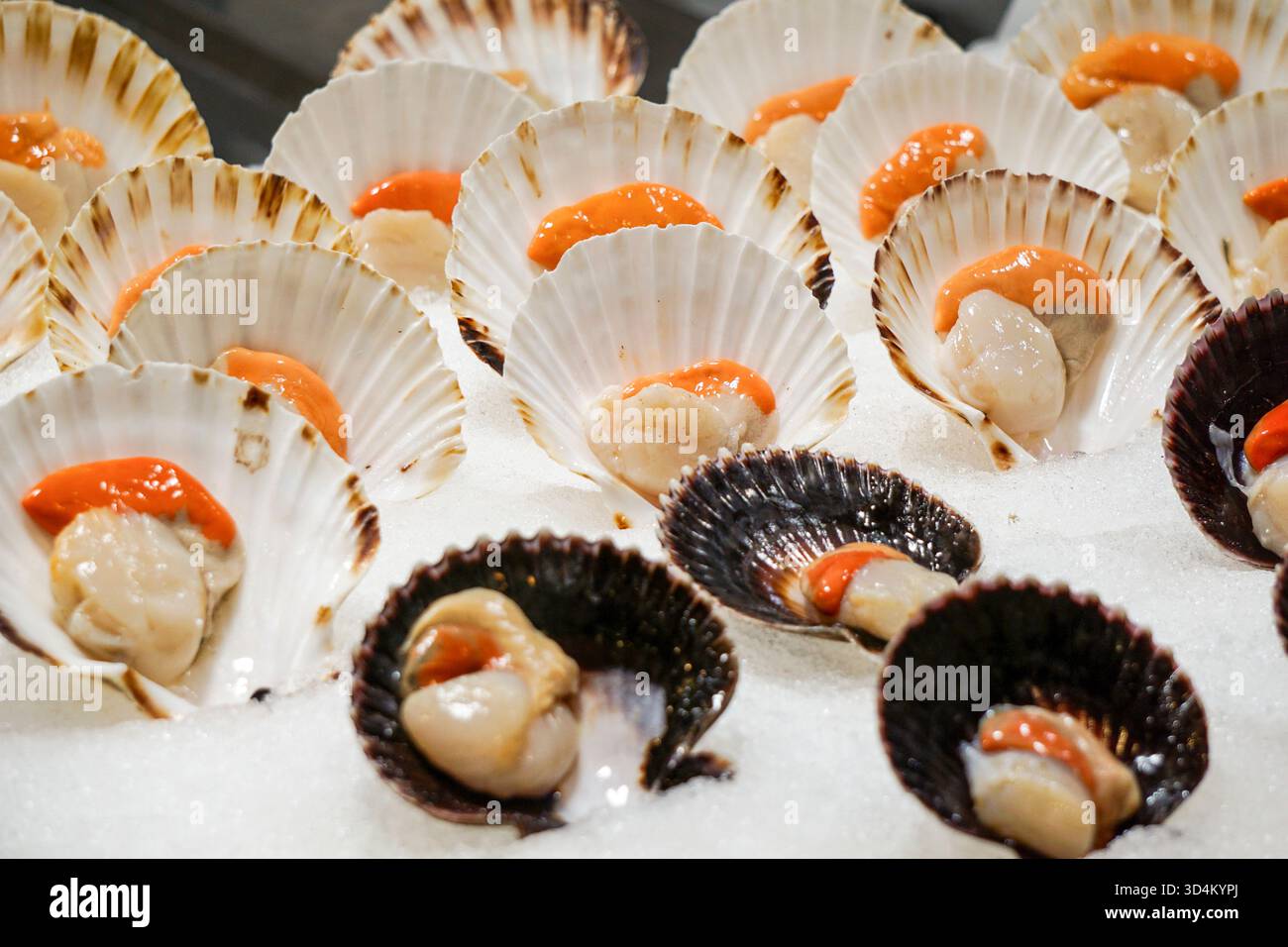 fresh scallops displayed on crushed ice at a seafood market Stock Photo ...