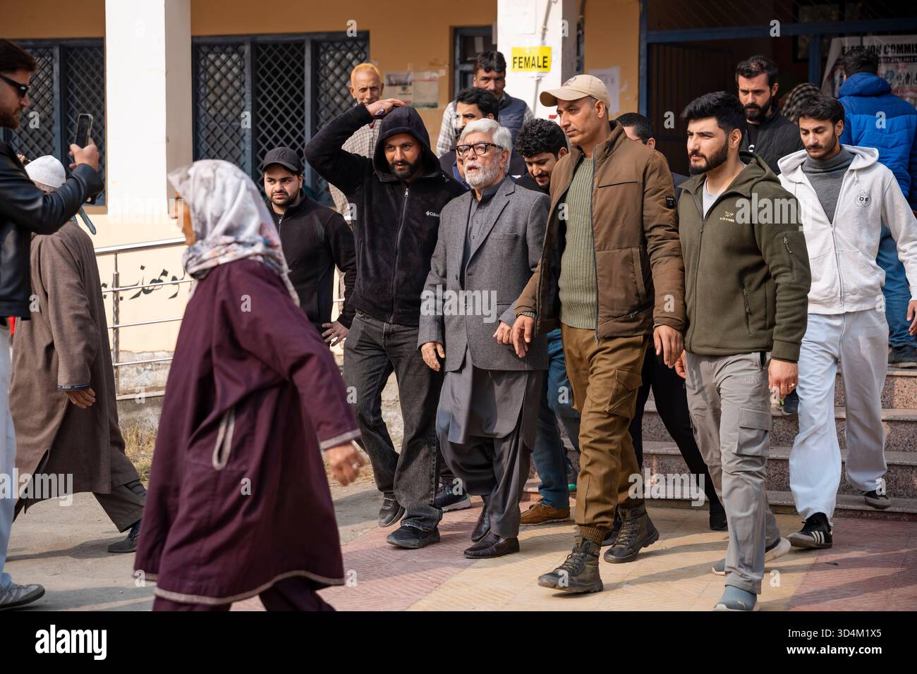 National Conference candidate Aga Syed Mahmood leaves a polling booth ...