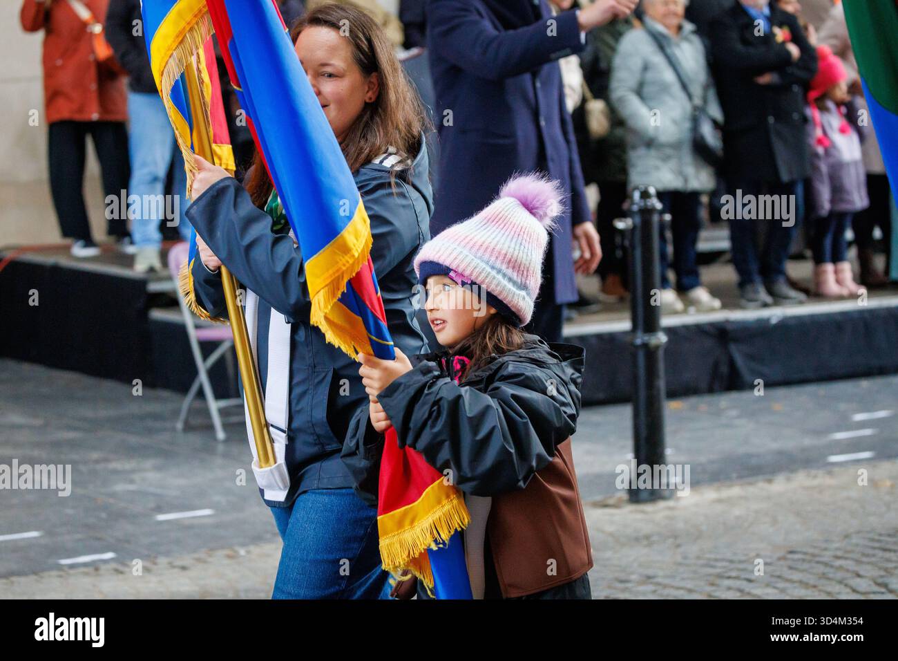 Civilians holding a flag during the 'Poppy Parade' walk of the Last ...