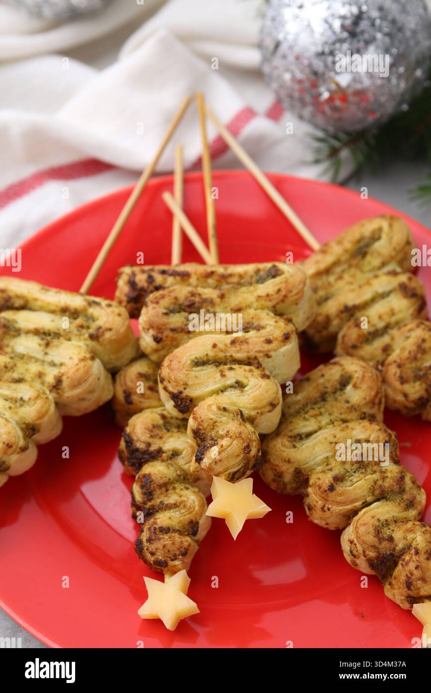 Christmas tree shaped snacks made with puff pastry, pesto sauce, cheese ...