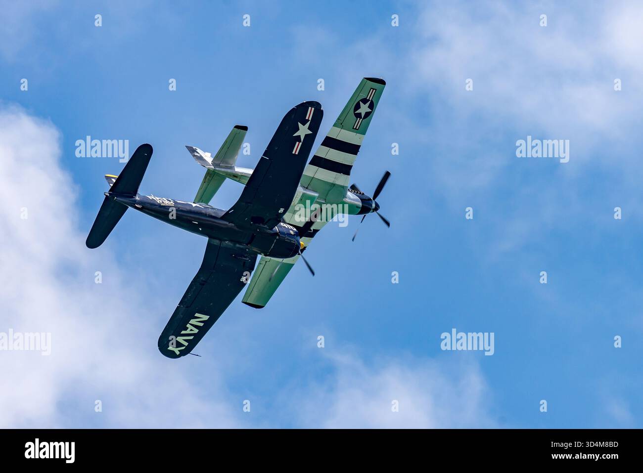 WWII Corsair and P-51 attack aircraft fly together durning an airshow ...