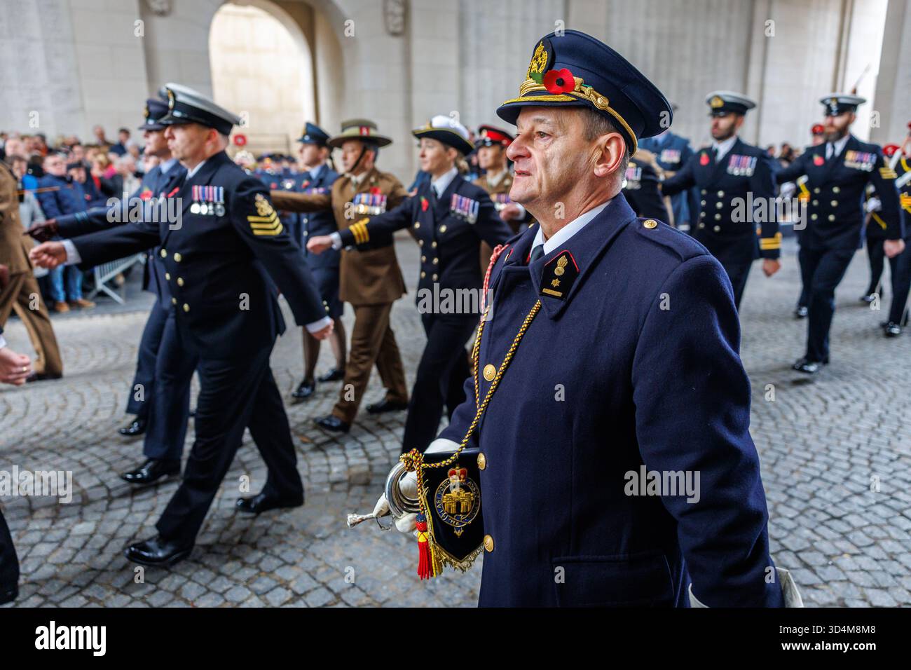 Armed service members marching under the Menin Gate during the 'Poppy ...