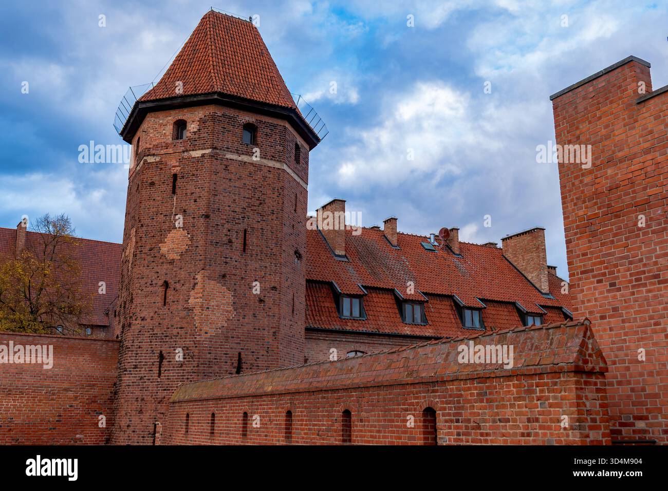 Red brick Gothic tower and crenellated walls of Malbork Castle in ...
