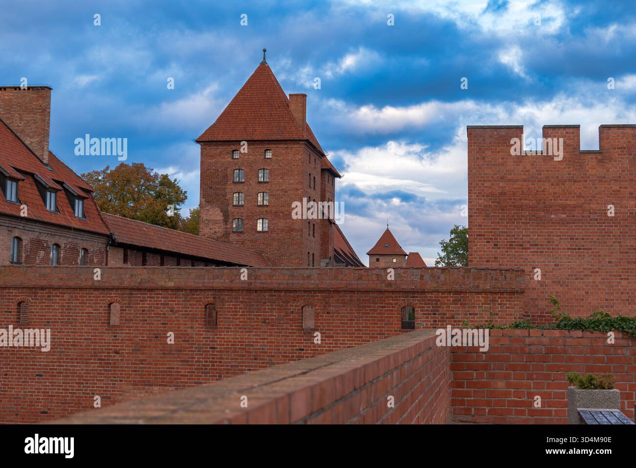 Red brick Gothic walls, towers, and crenellated ramparts of Malbork ...