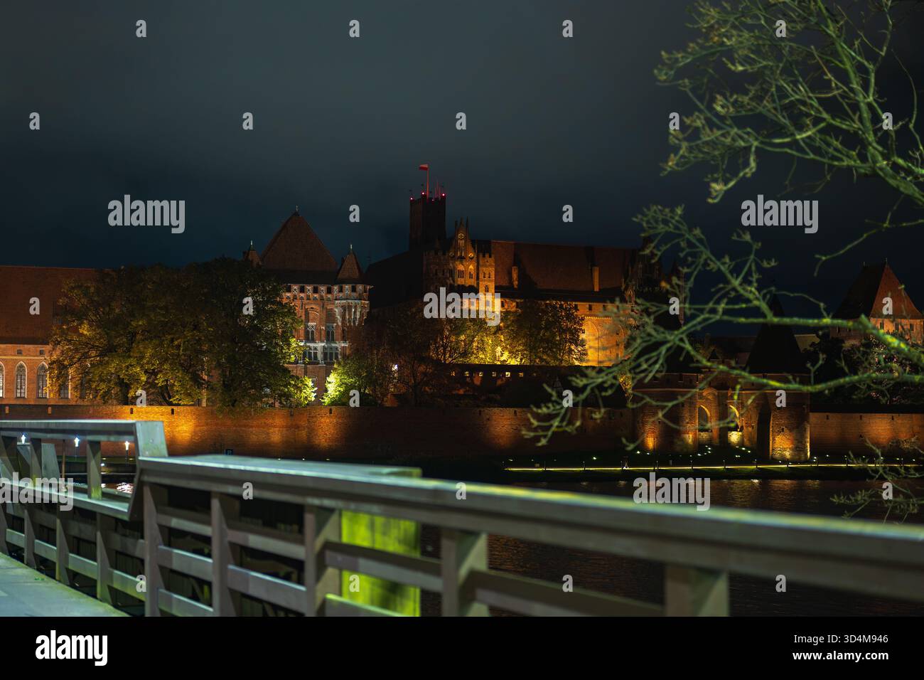 Malbork Castle in Malbork, Poland rises beyond the Nogat River, red ...