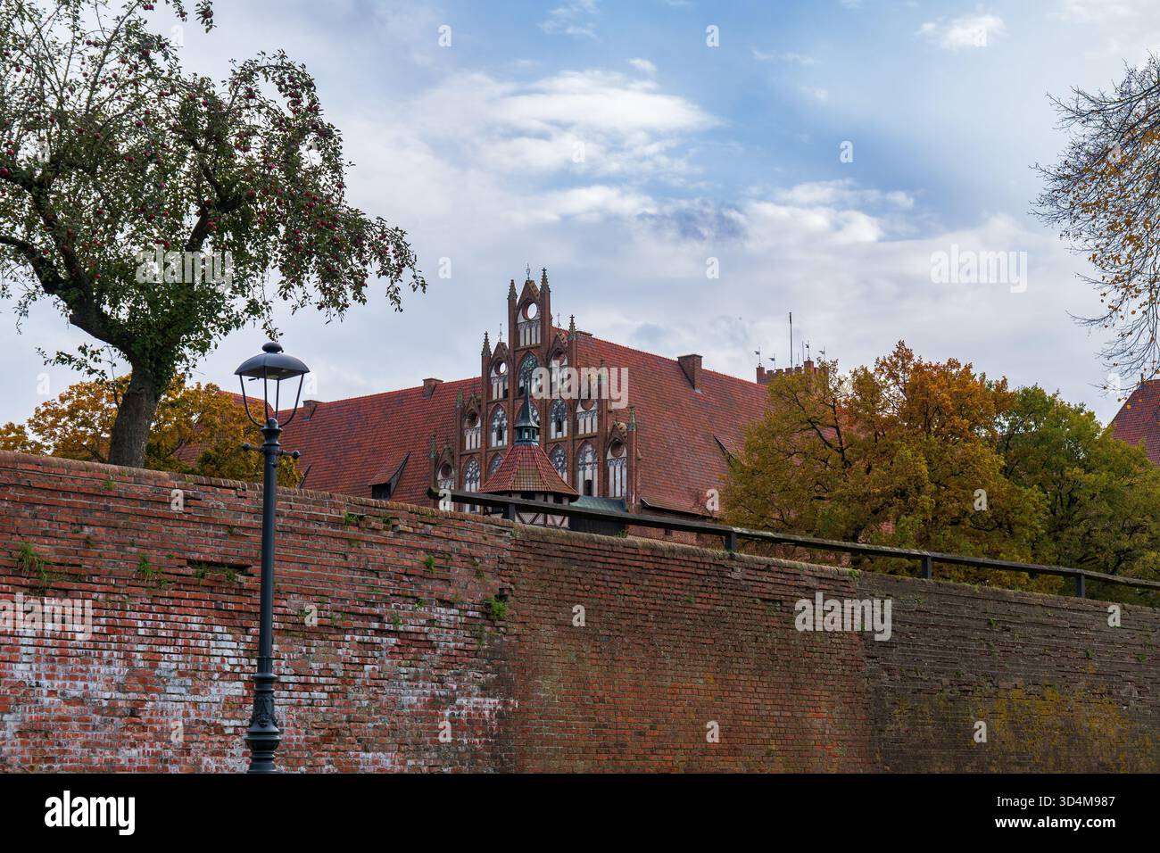 Red brick Gothic Malbork Castle in Malbork, Poland rises above a high ...
