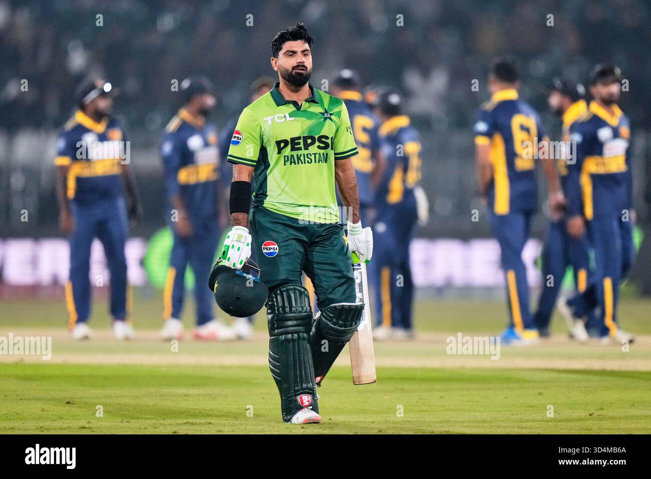 Pakistan's Hussain Talat, center, from, walks off the field after his ...