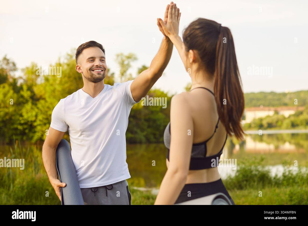 Couple giving high five each other rejoicing the success in sport ...
