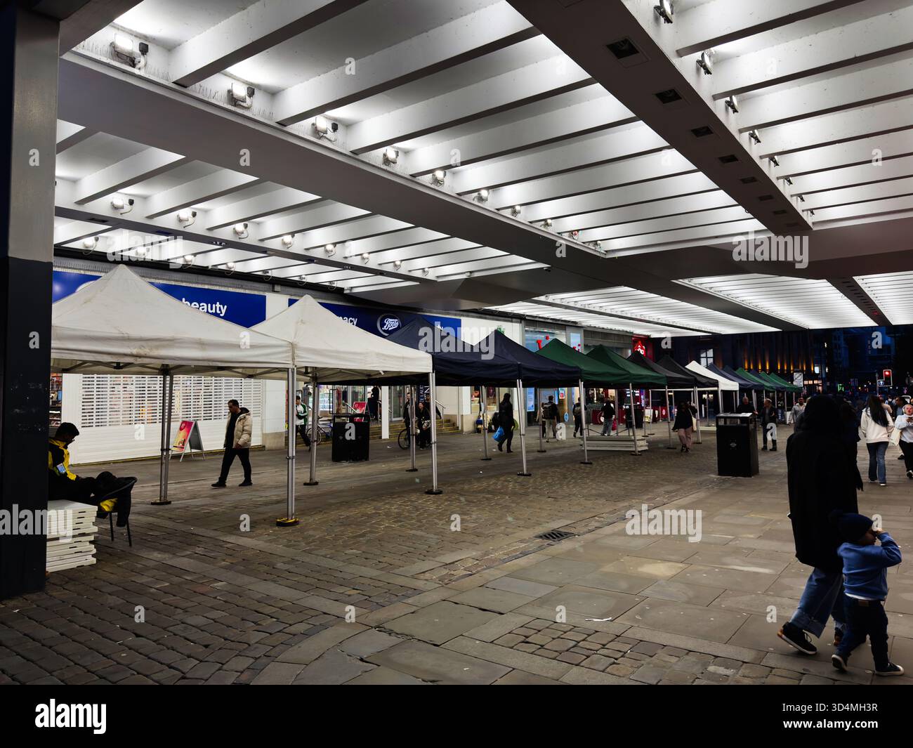 Manchester, UK - September 30, 2025: Shoppers browse colorful stalls ...
