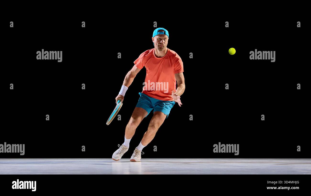 Focused tennis player tracking ball with strong eye contact and balance ...