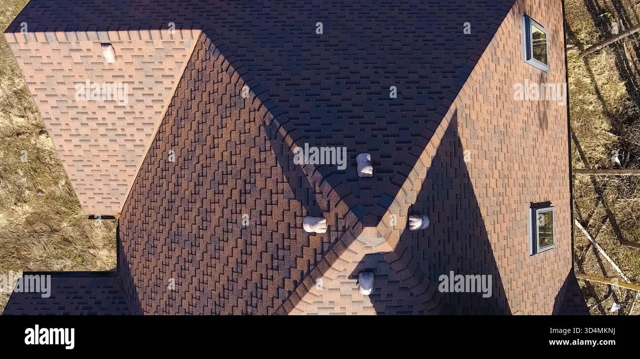 House with a roof from a bituminous tile. Bituminous tile for a roof. a ...