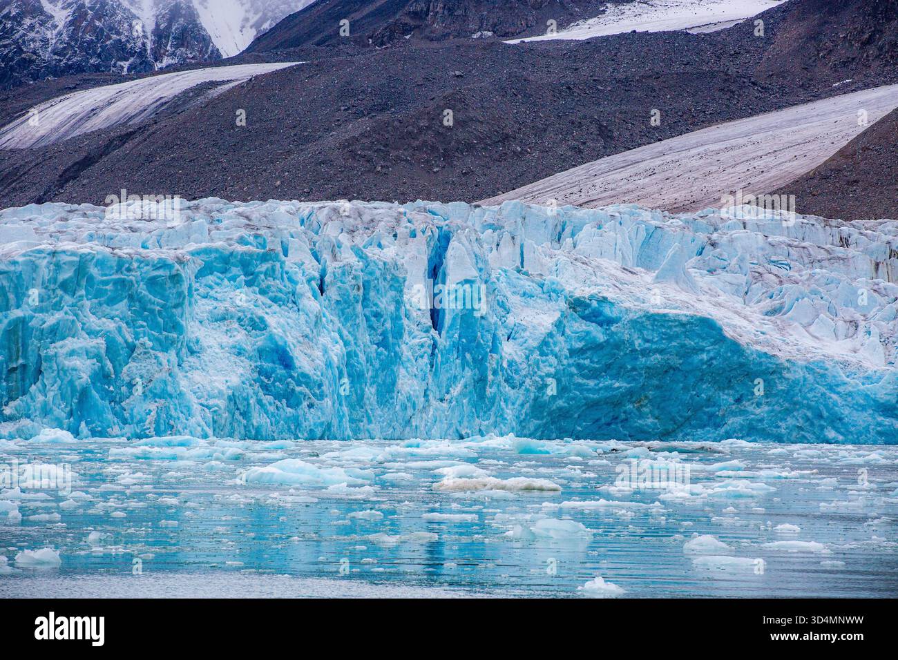 Svalbard cruise - Large blue ice wall is surrounded by a body of water ...