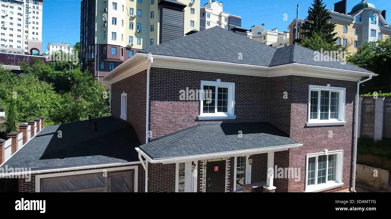 House with a roof from a bituminous tile. Bituminous tile for a roof. a ...