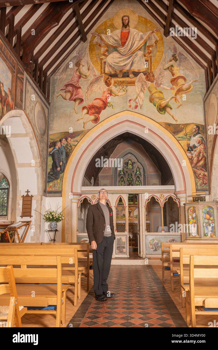 The Reverend Canon, Peter Blee, admires the mural paintings by members ...