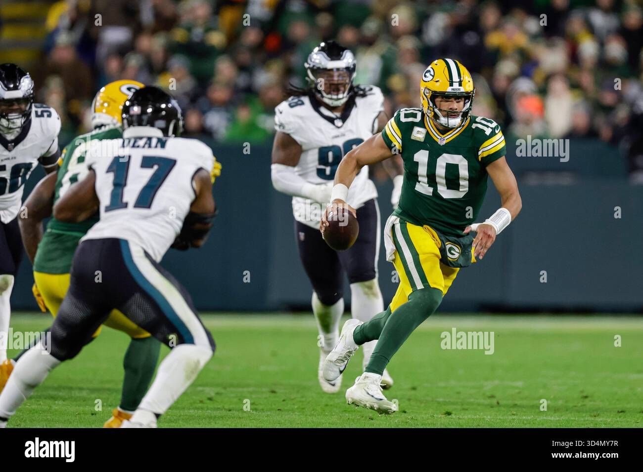Green Bay Packers quarterback Jordan Love (10) rolls out of the pocket ...