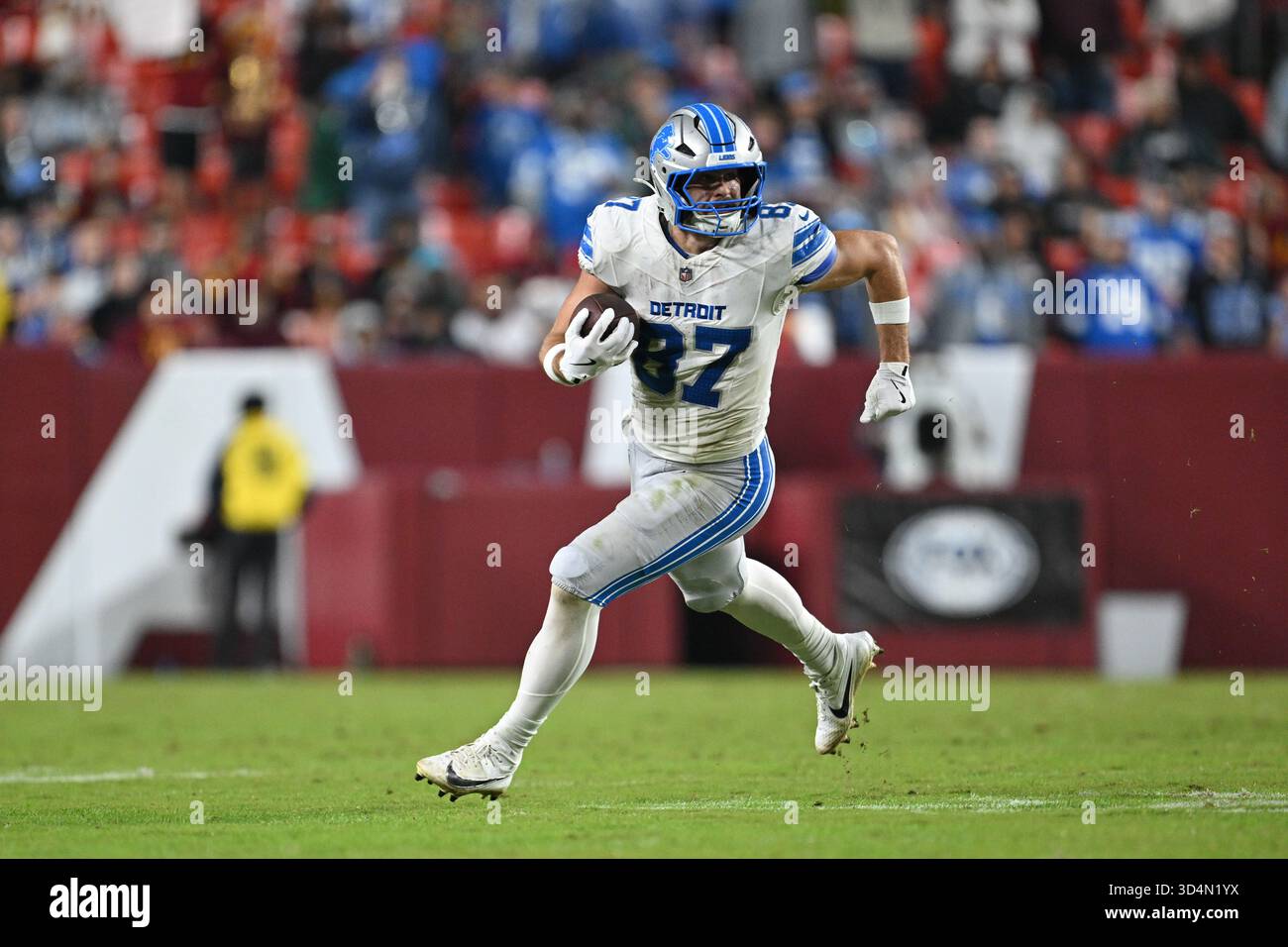 Detroit Lions tight end Sam LaPorta runs with the ball after catching a ...