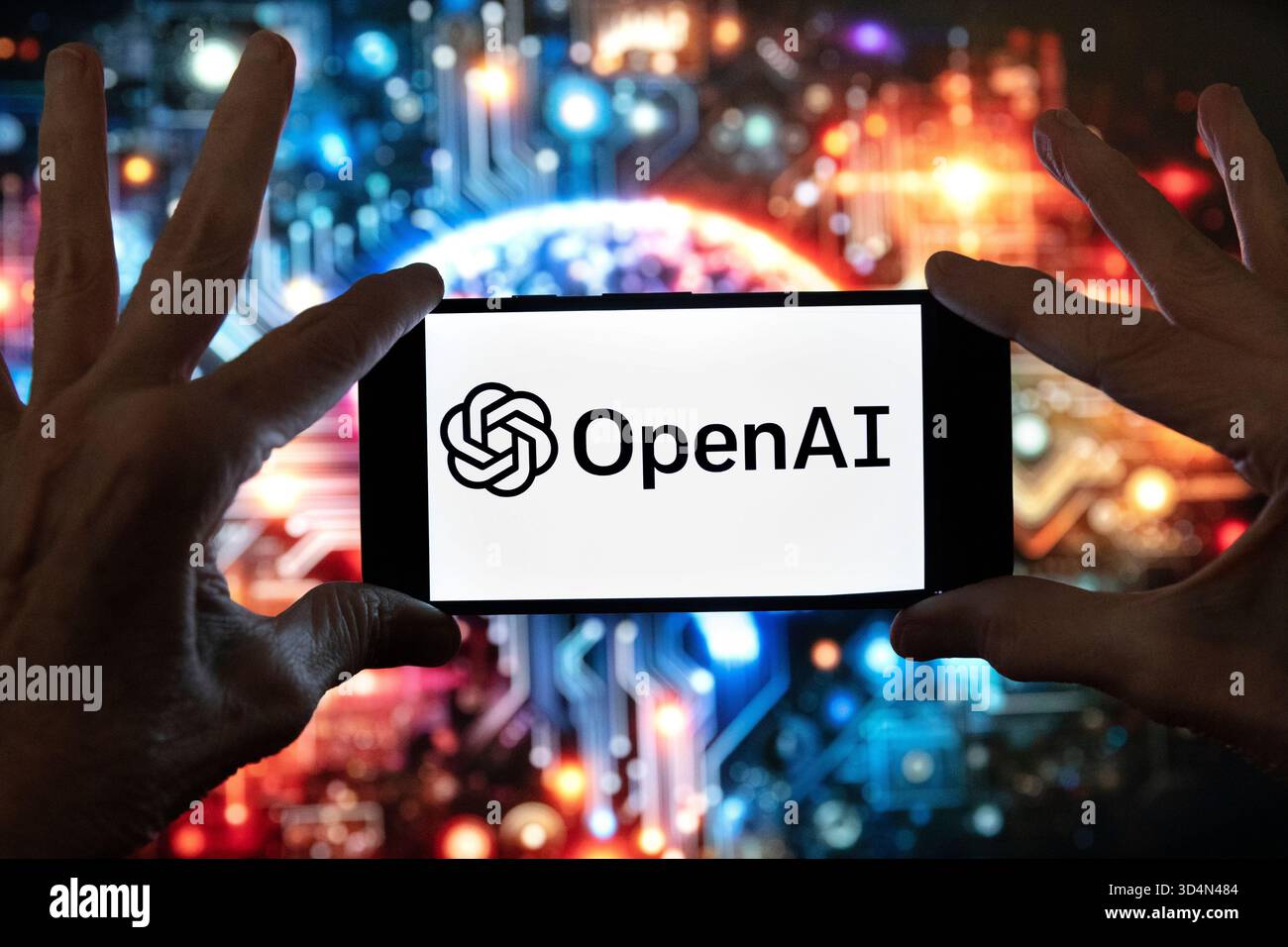 FILE - The OpenAI logo is seen displayed on a cell phone in front of an ...