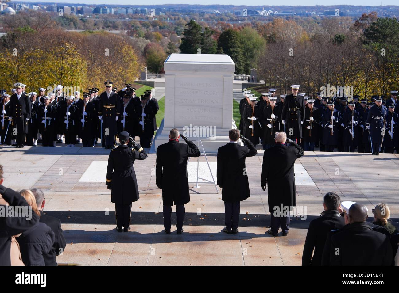 President Donald Trump, right, salutes as he arrives to lay a wreath at ...