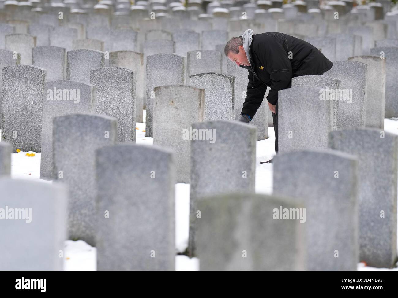 A man walks amongst the rows of fallen Canadian soldiers as he pay his ...