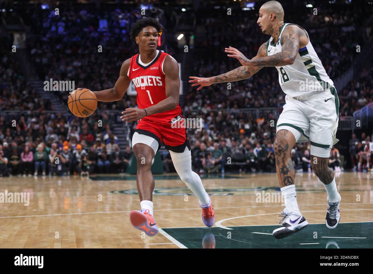 Houston Rockets' Amen Thompson drives against Milwaukee Bucks' Kyle ...