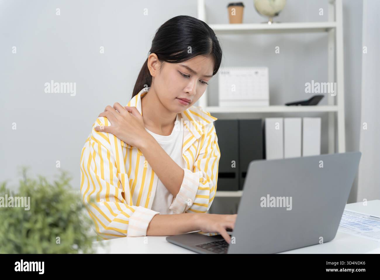 woman holding on shoulder and while and suffer from unbearable pain ...