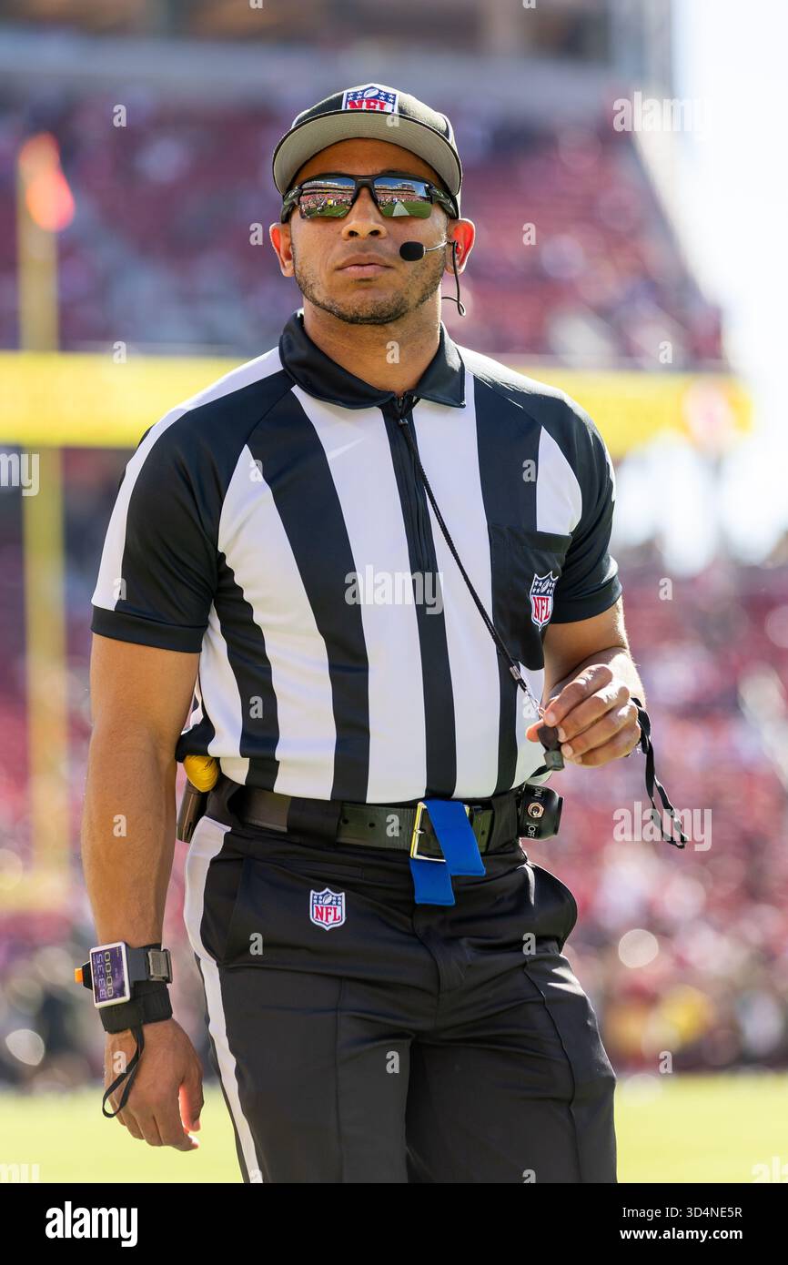 NFL side judge Dominique Pender (114) walks the sideline before the Los ...