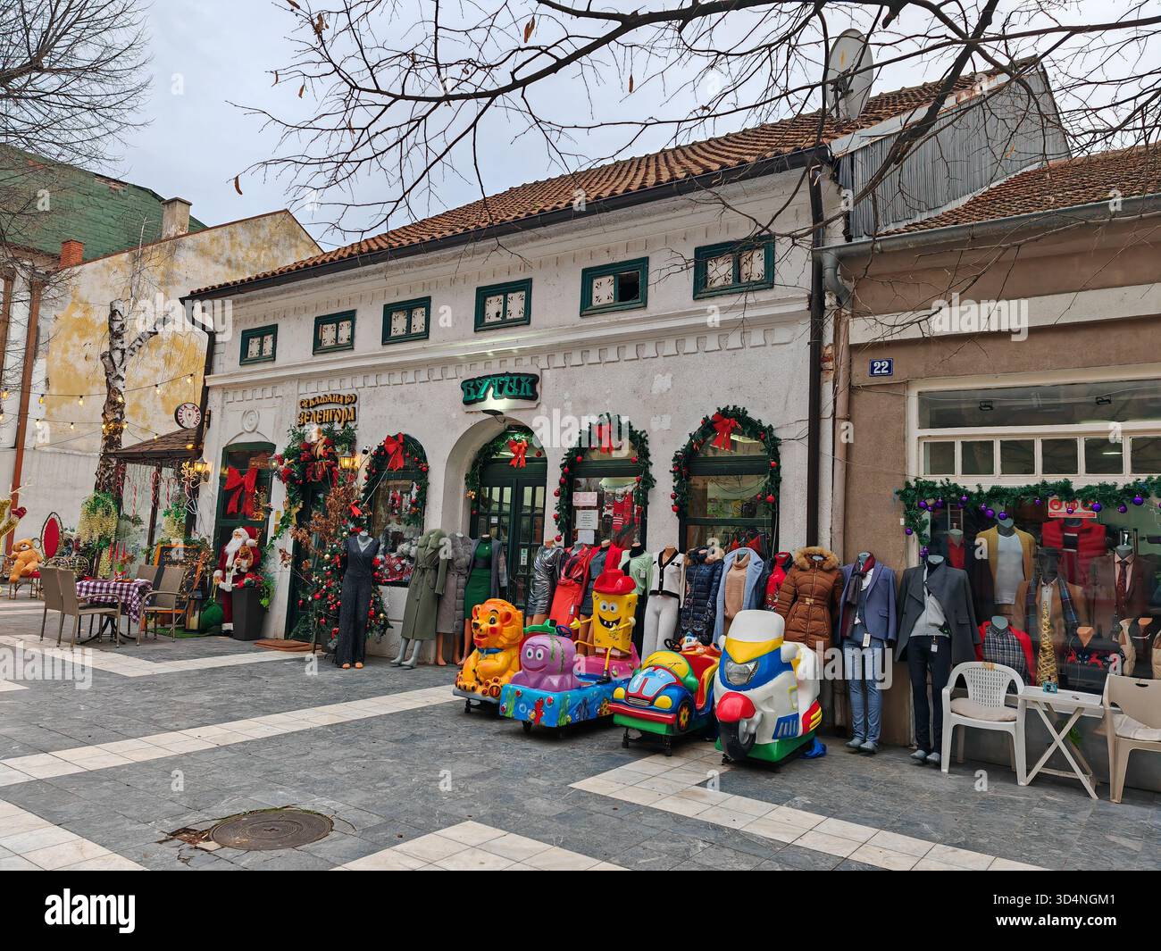 Street shop decorated for New Year 2026 with kids rides Stock Photo - Alamy