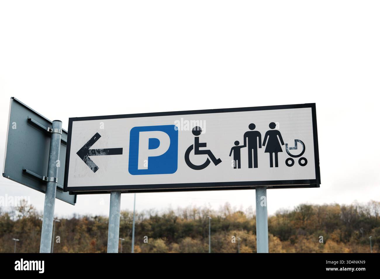 Outdoor sign showing directions for parking areas including family and ...