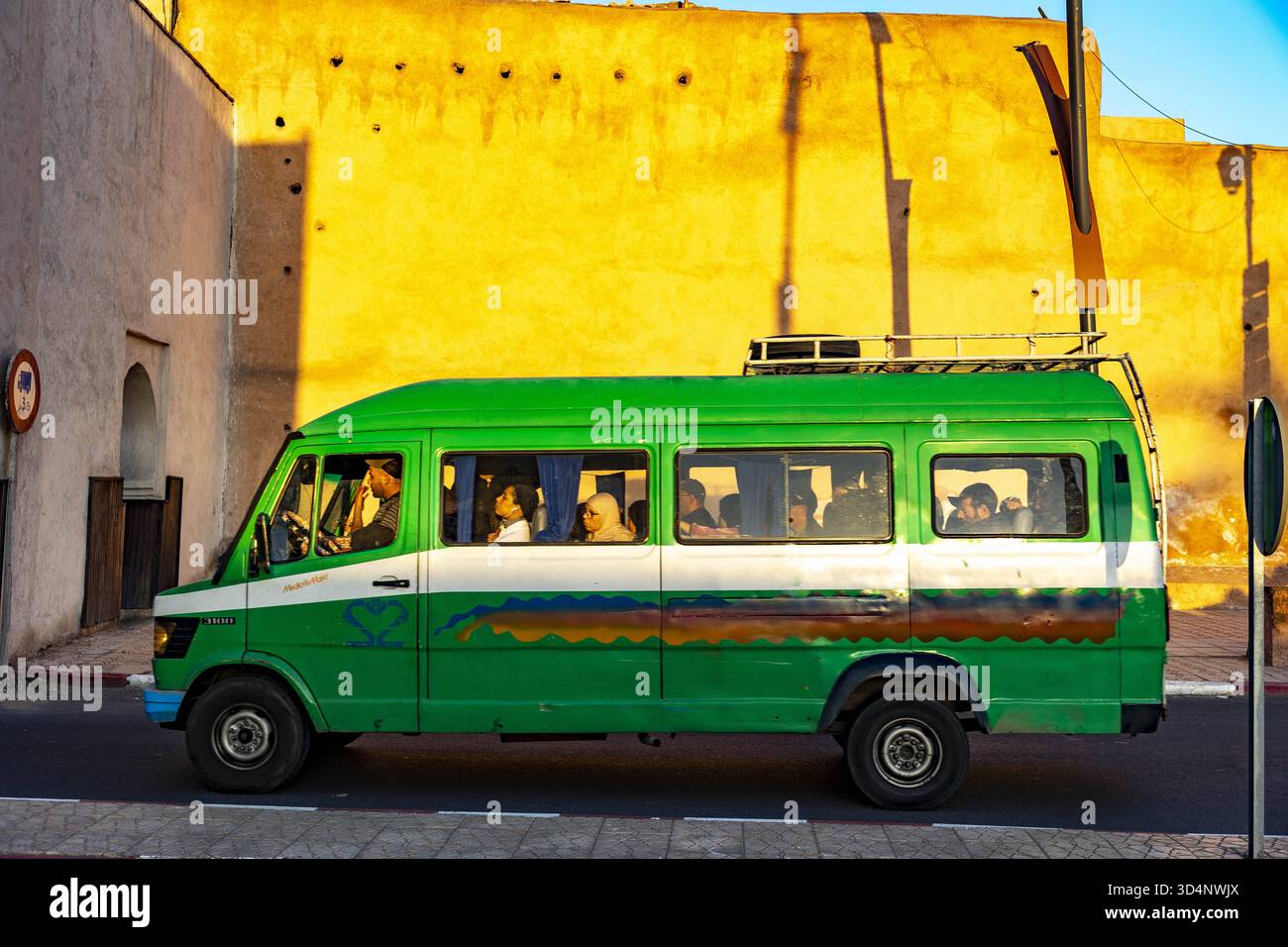 Green bus with passengers in Marrakesh, Morocco. Green bus with ...
