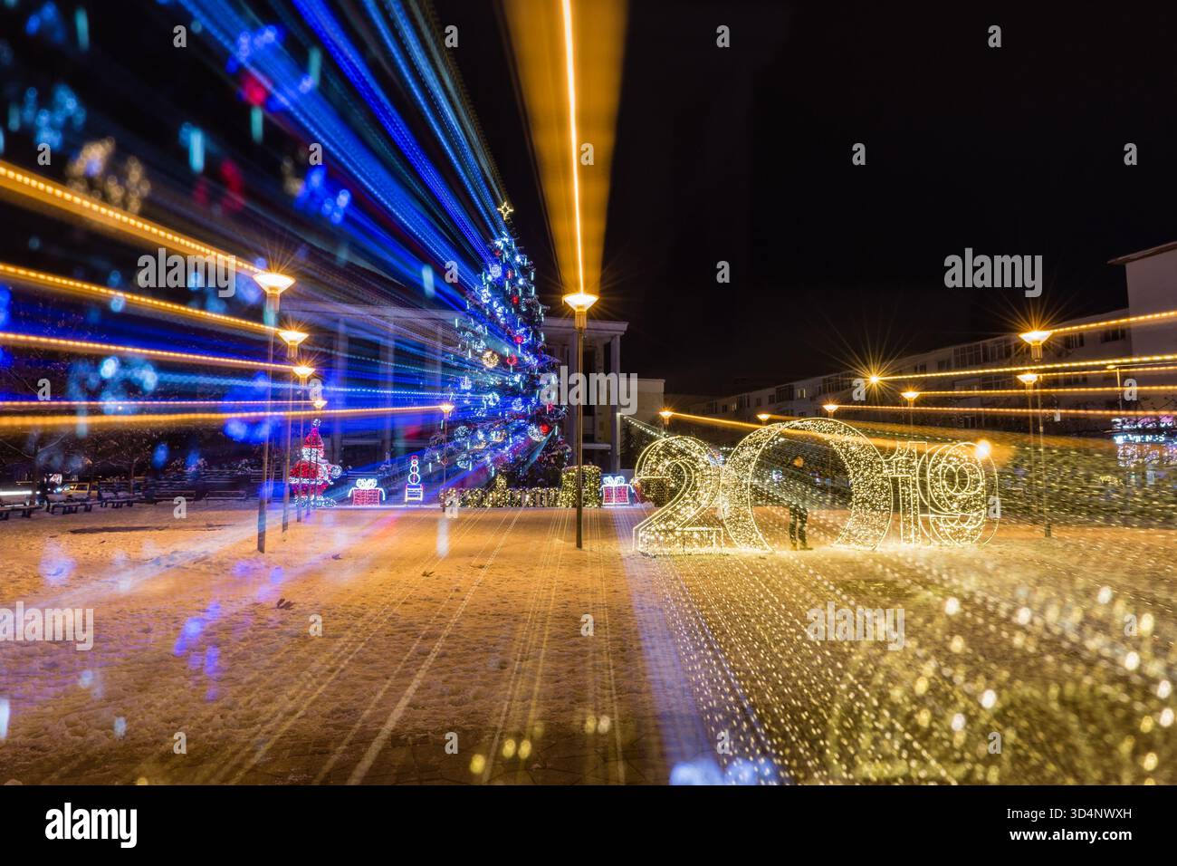 Outdoor Christmas tree with colorful lights and golden “2019” sign ...