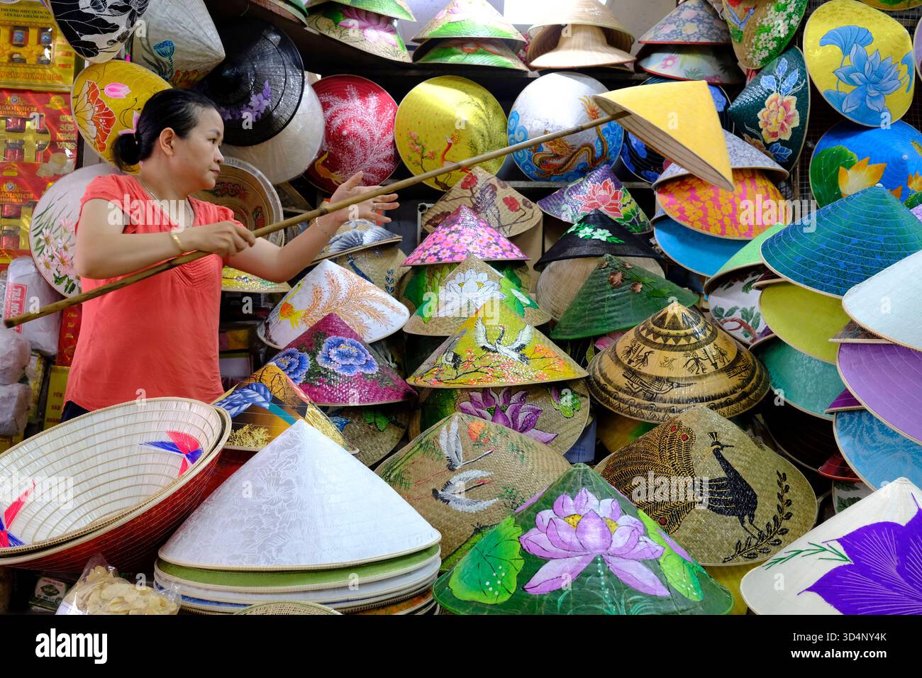 Paddy hats or conical straw hats for sale at a market stall in Dong Ba ...