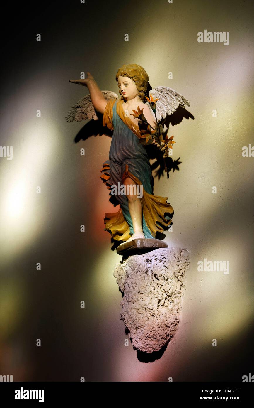 Saint Jean Baptiste church. Baroque angel in the light of a stained ...