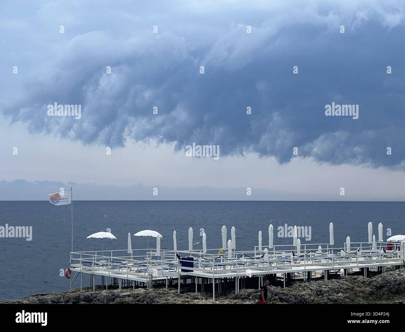 Empty waterfront holiday place on a cloudy day in Andrano, Italy. Cloud ...