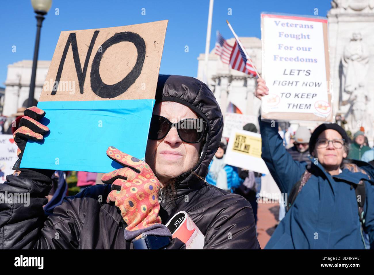 People hold signs as veterans and their supporters rally outside Union ...
