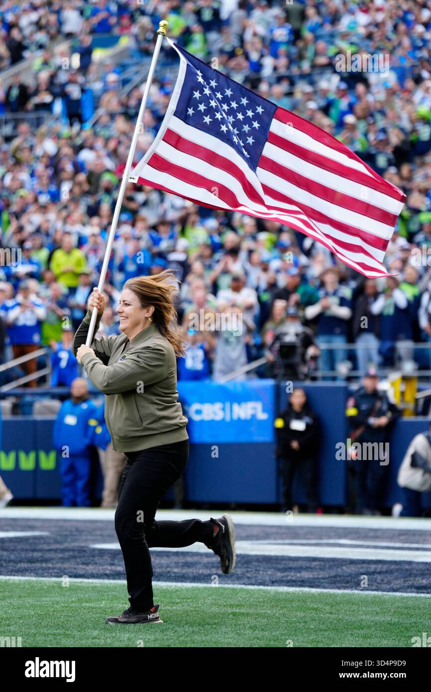 Captain Shannon Huffman Polson carries the United States flag on to the ...