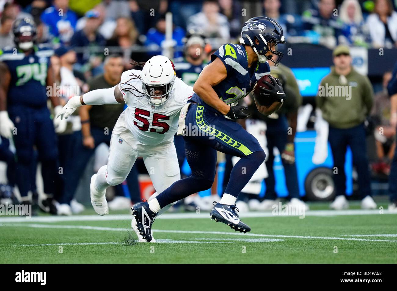 Arizona Cardinals defensive tackle Dante Stills (55) grabs at Seattle Seahawks running back Zach ...
